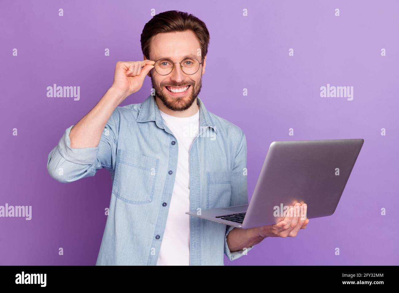 Photo of cheerful happy young man good mood job hold laptop smile ...
