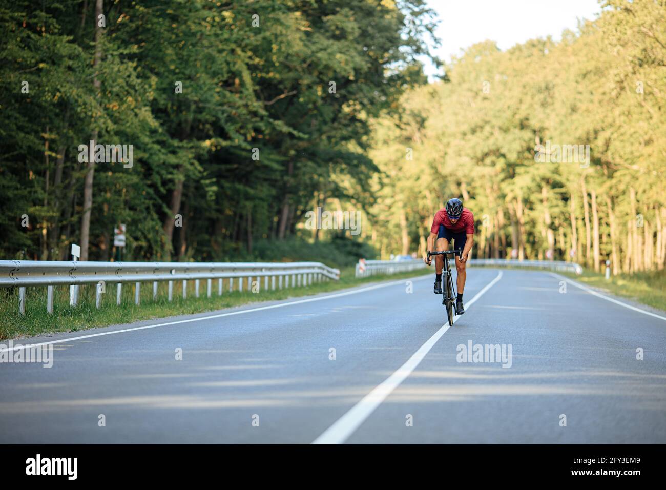 Man riding bike with high speed on asphalt road Stock Photo - Alamy