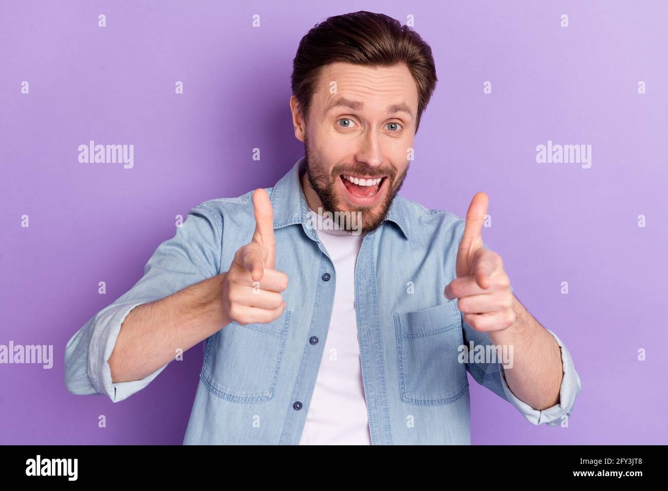 Photo of clever funky young guy wear denim clothes open mouth pointing ...