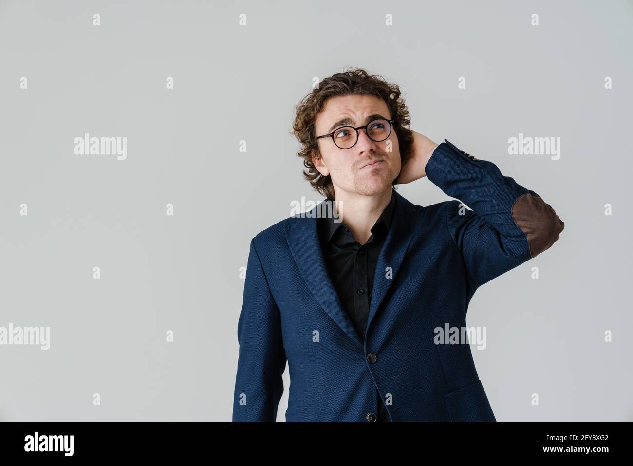 Brooding handsome man in eyeglasses thinking and looking aside isolated ...