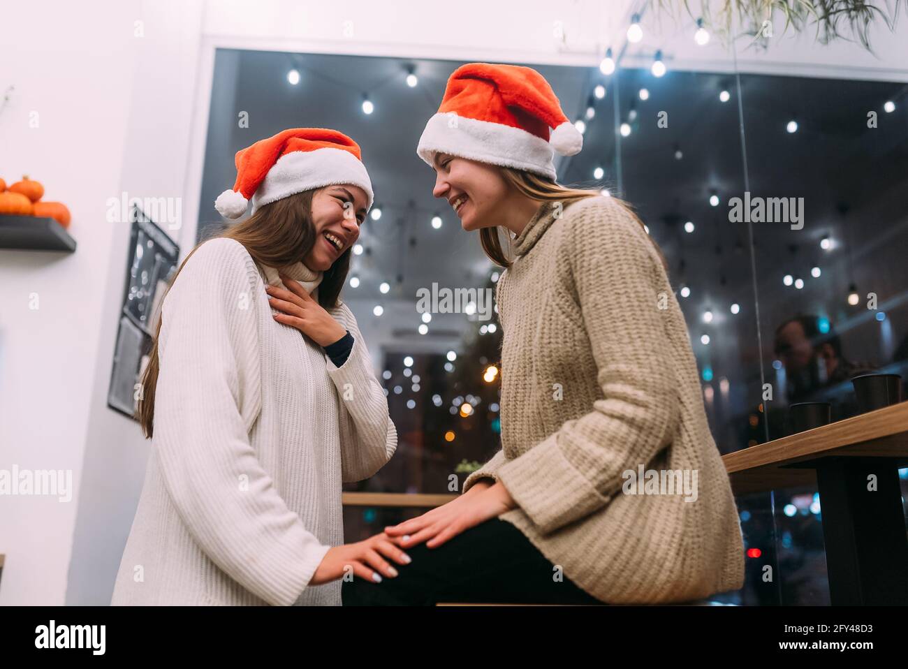 Portrait of happy cute young friends having fun in cafe Stock Photo - Alamy