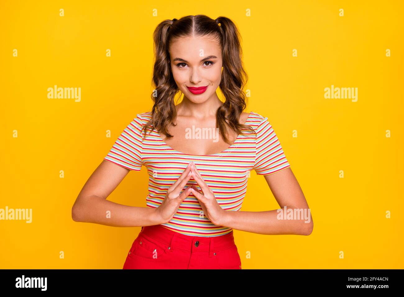 Photo of sly sneaky evil lady with ponytails hold fingers wear striped ...