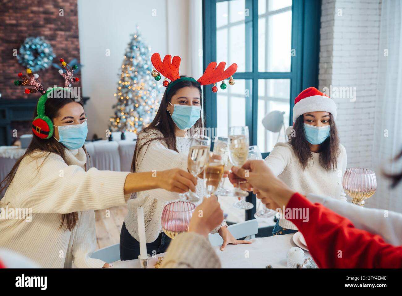 Multi-ethnic young people celebrating New year eve at party Stock Photo ...