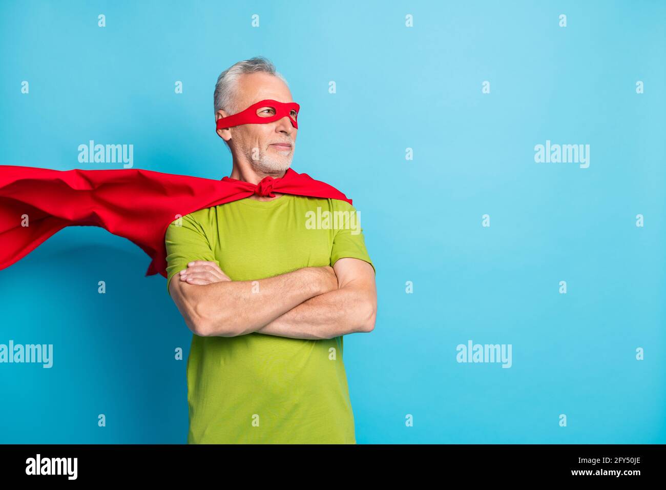 Portrait of attractive strong grey-haired superman folded arms copy ...