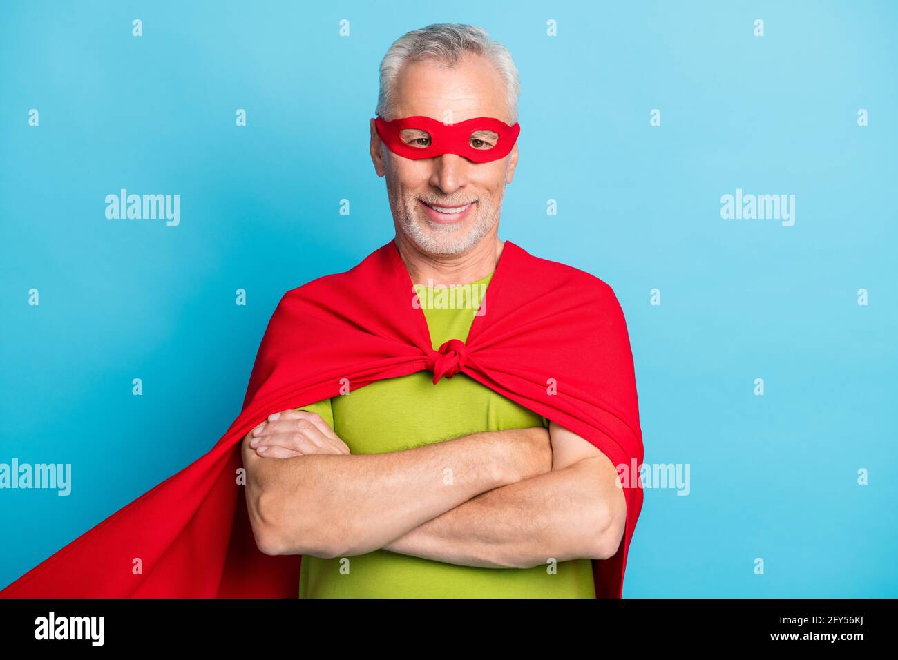 Portrait of handsome strong cheerful grey-haired superman folded arms ...
