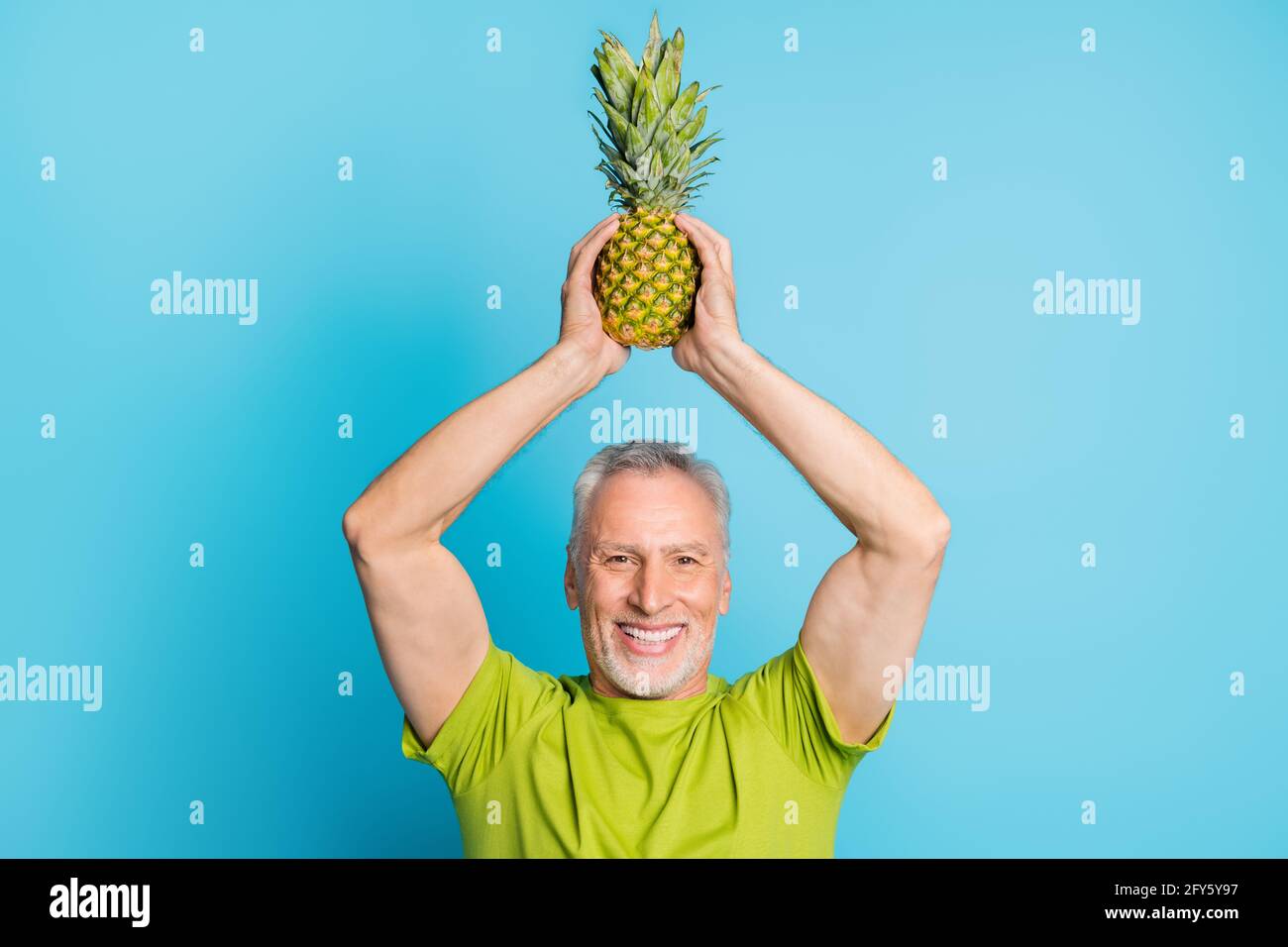 Portrait of attractive cheerful grey-haired man rising up holding in ...