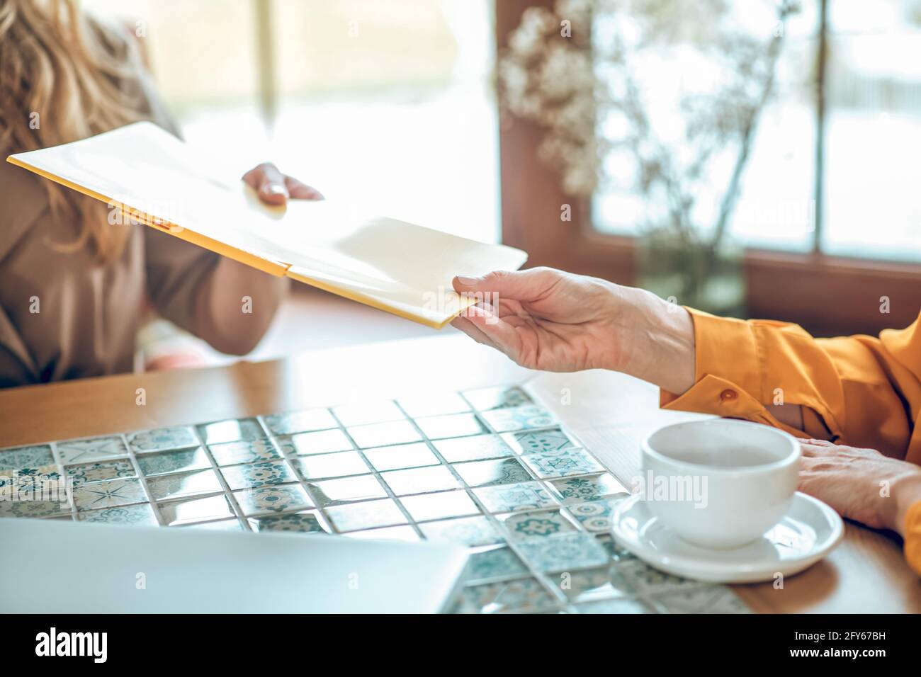 Hand passing papers hi-res stock photography and images - Alamy