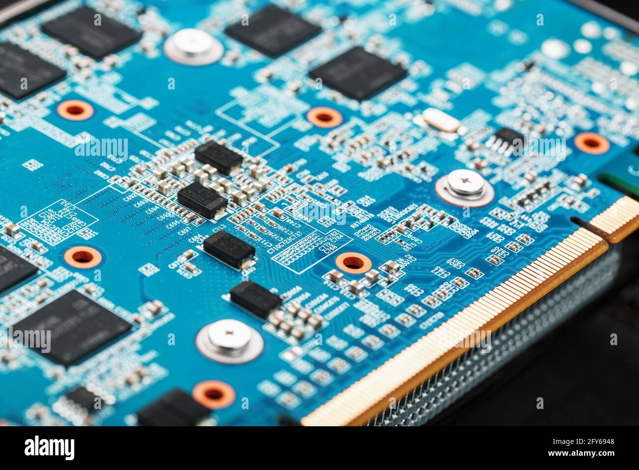 A blue board with chips and a gaming graphics card processor ...