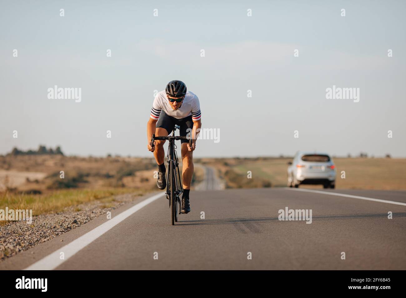 Professional cyclist racing on asphalt road Stock Photo - Alamy