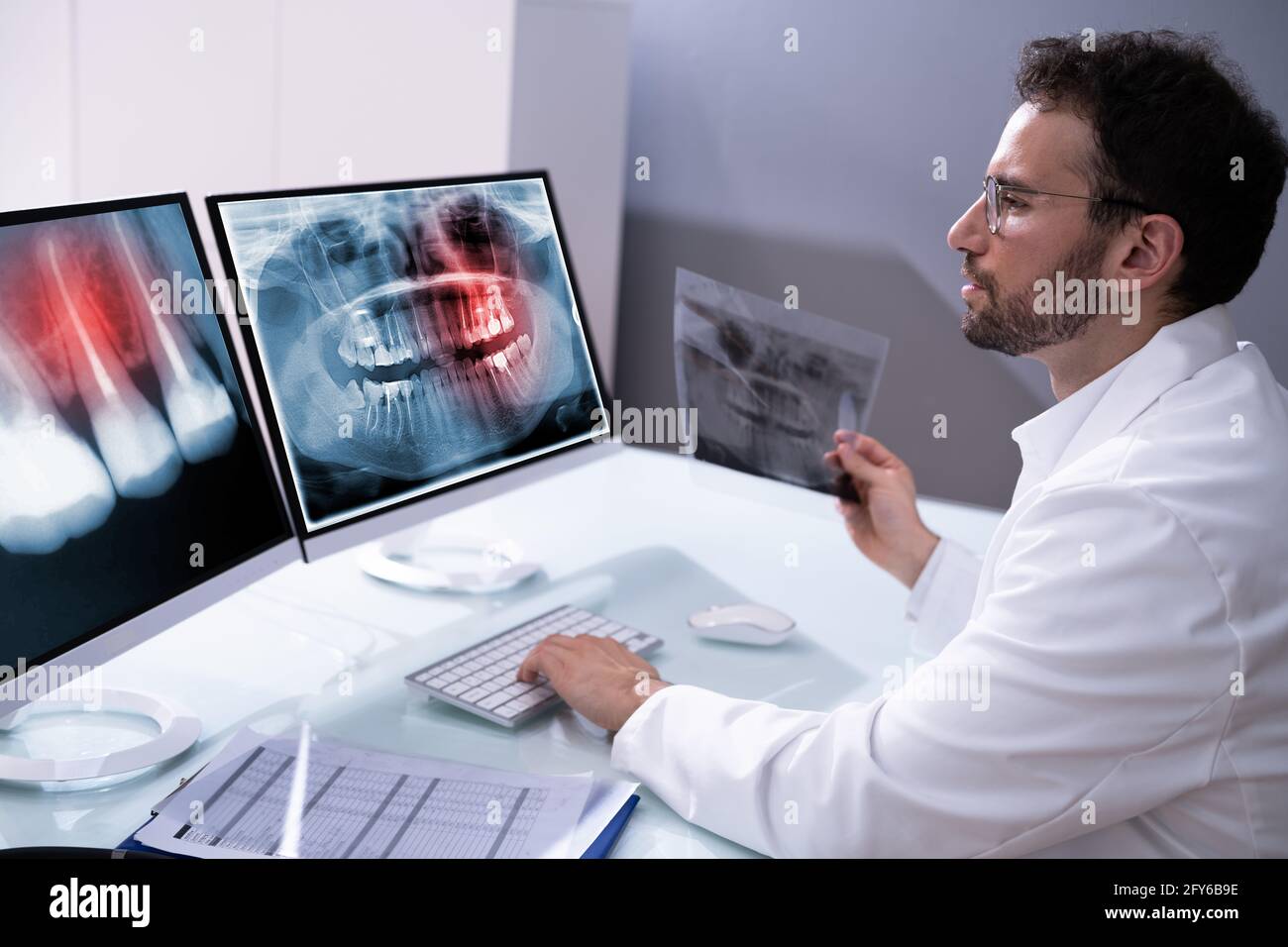 Radiologist Dentist Using X Ray Software On Desktop Computer Stock ...