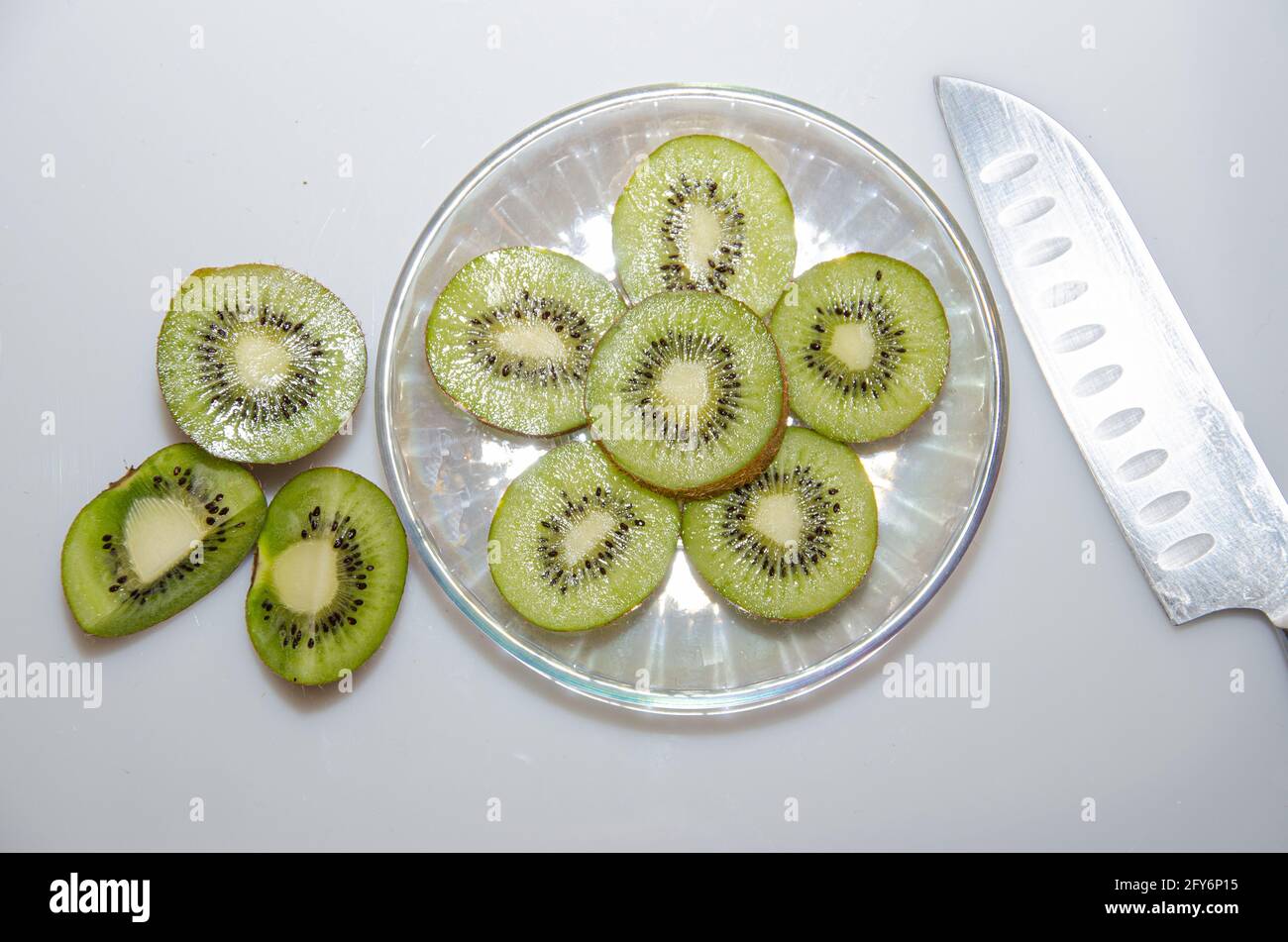 Kiwi fruit cut into pieces cook white Stock Photo - Alamy