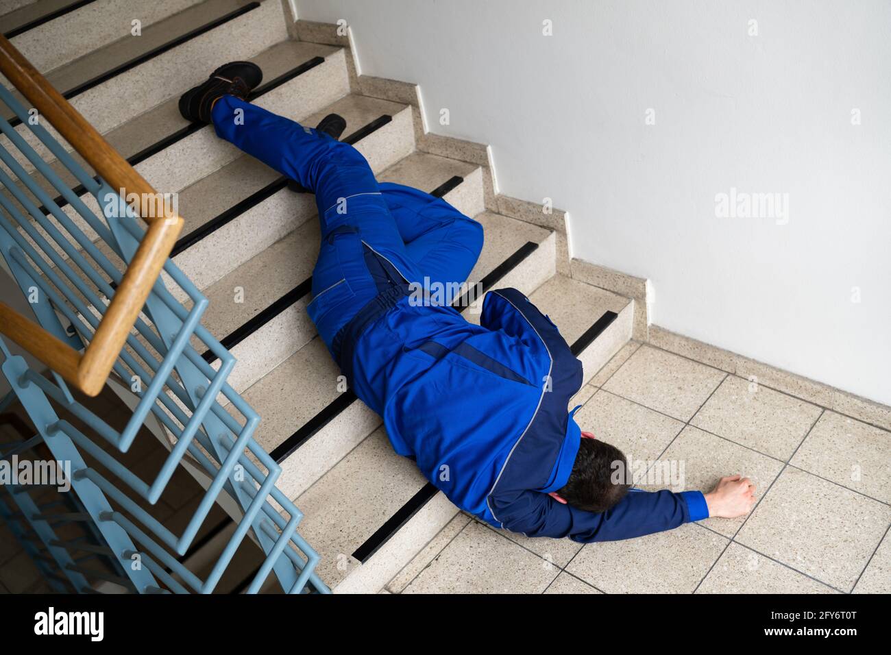 Worker Man Lying On Staircase After Slip And Fall Accident Stock Photo ...