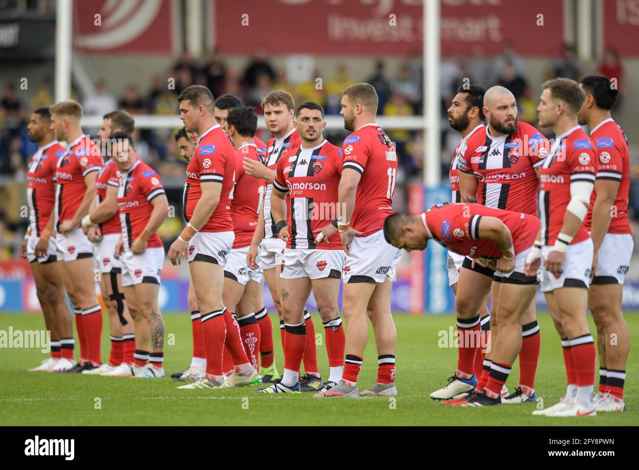 The Salford Red Devils players line up before the game Stock Photo - Alamy