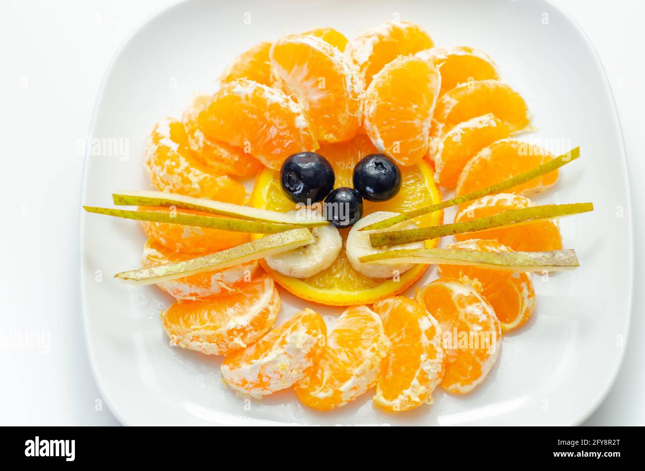 Fresh fruit orange, mandarin, banana, grape and pear served in a ...