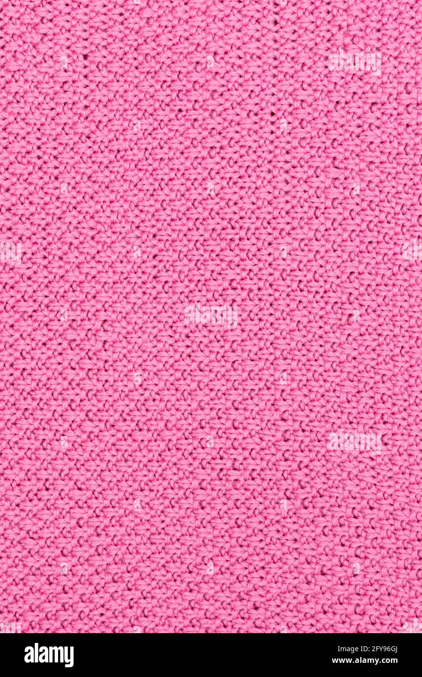Pink knitted fabric pearl woolen background. The structure of the ...
