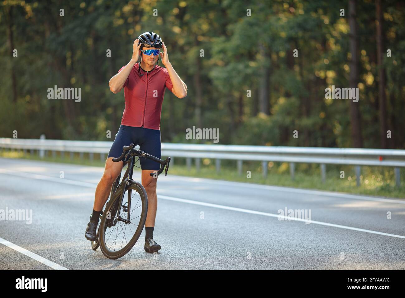 Cyclist wearing helmet for protection during riding Stock Photo - Alamy