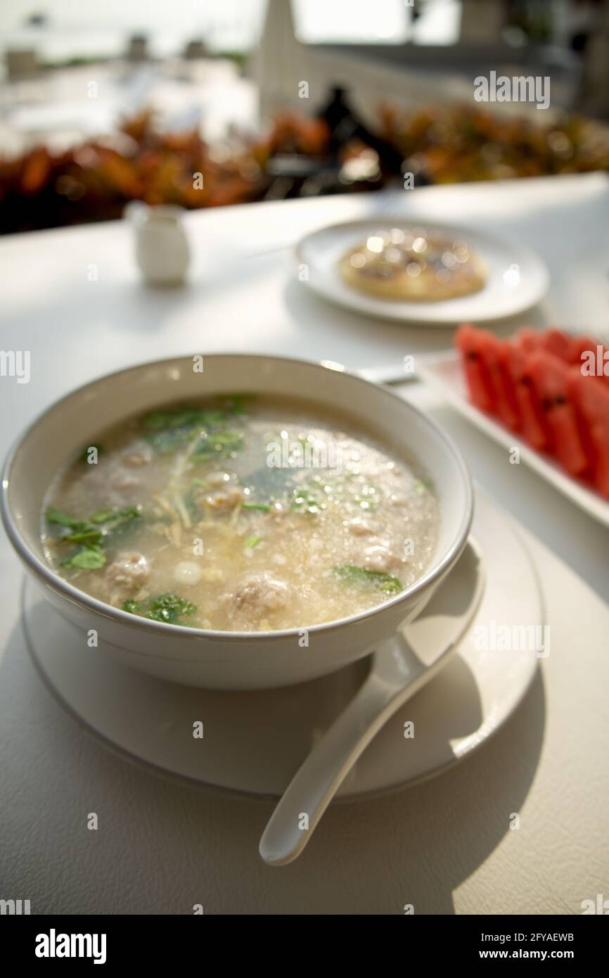 Vertical shot of a vegetable soup for vegetarians in the dinner table ...