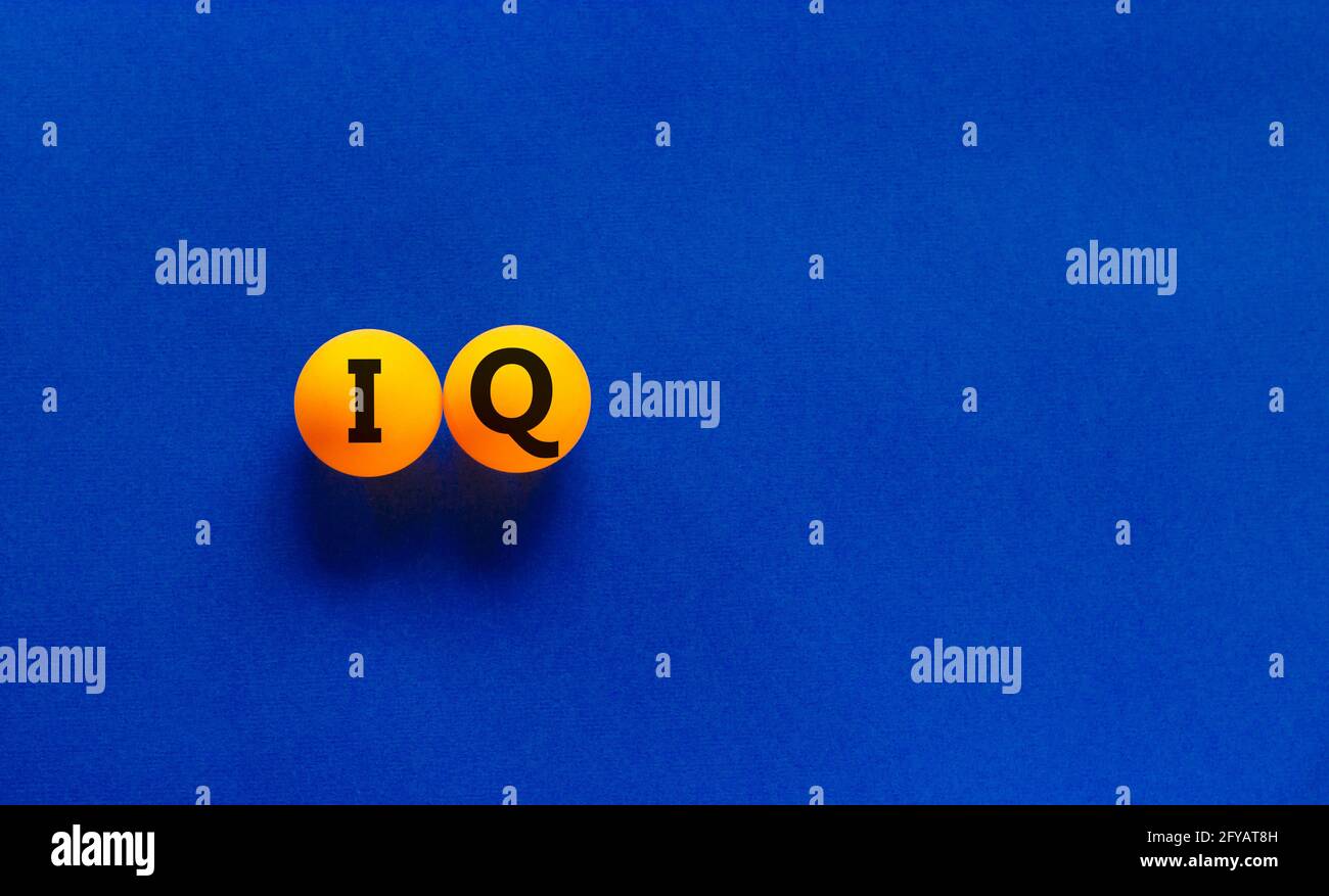 IQ, intelligence quotient symbol. Orange table tennis balls with words ...