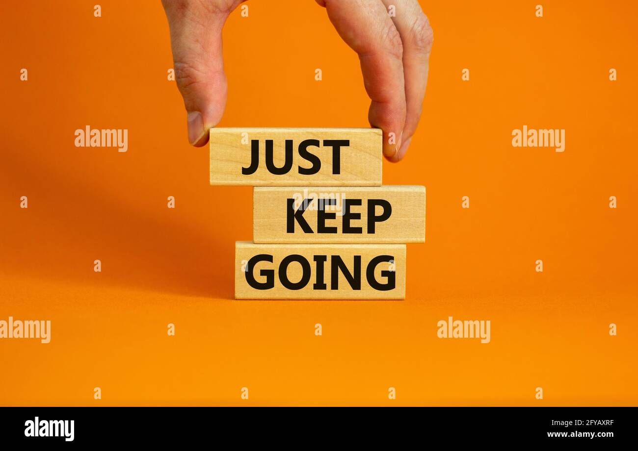 Just keep going symbol. Wooden blocks with words 'Just keep going ...