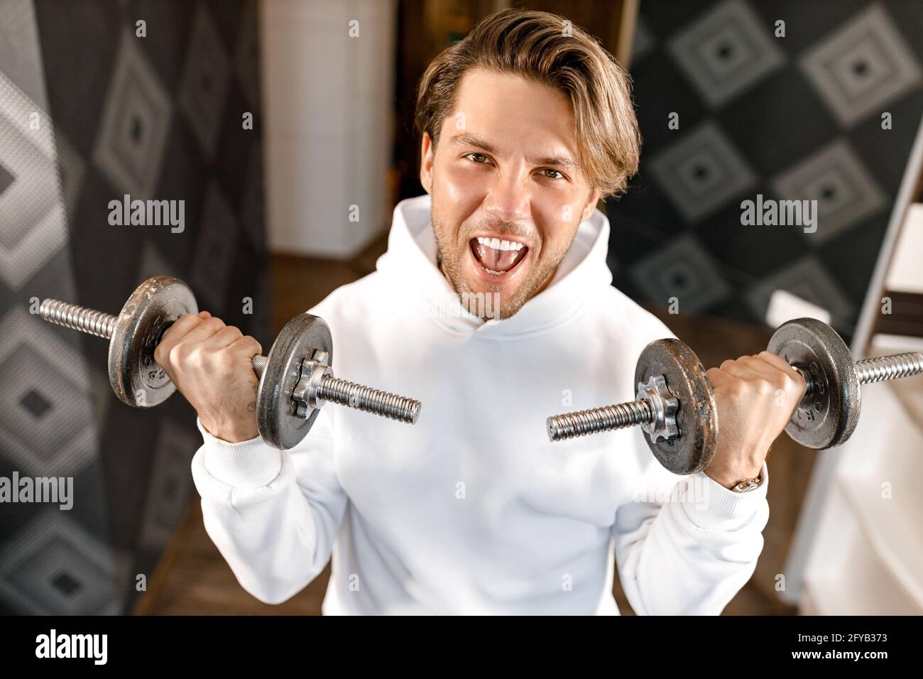 Portrait of young attractive joyful caucasian athletic man working out ...