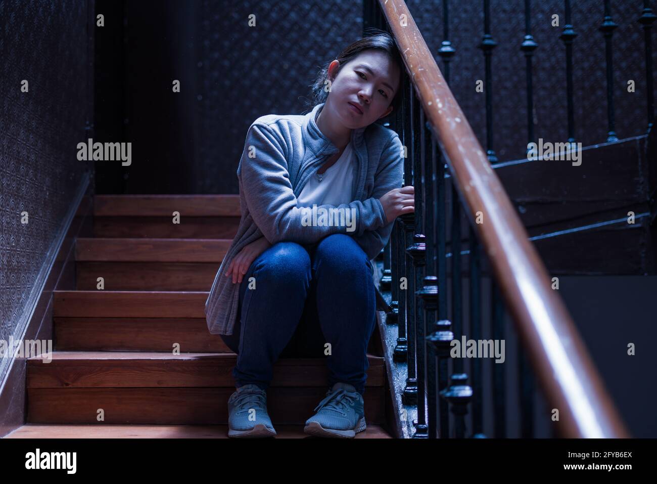 young beautiful Asian woman in pain suffering depression - dramatic ...