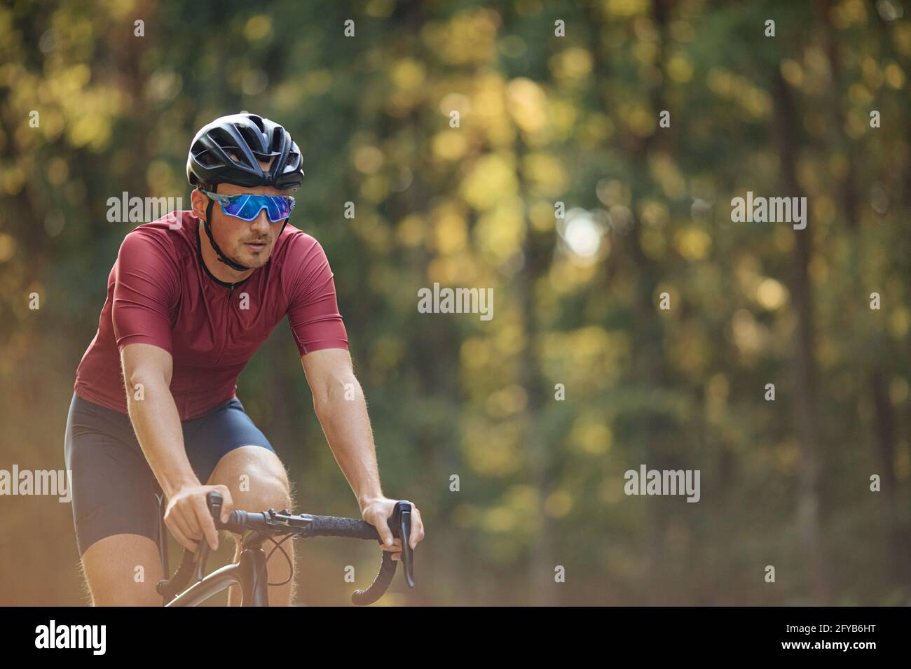 Muscular man enjoying bike riding on fresh air Stock Photo - Alamy