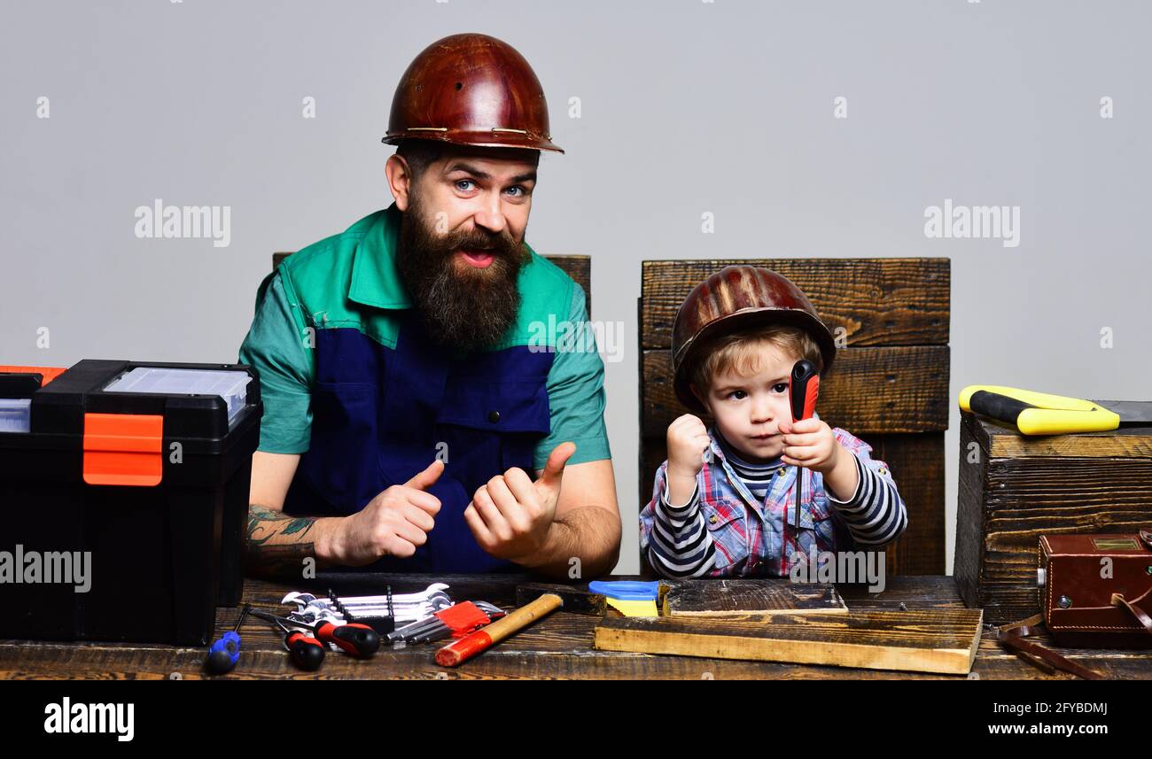 Concentrated boy with father repairing together. Dad teaching little ...