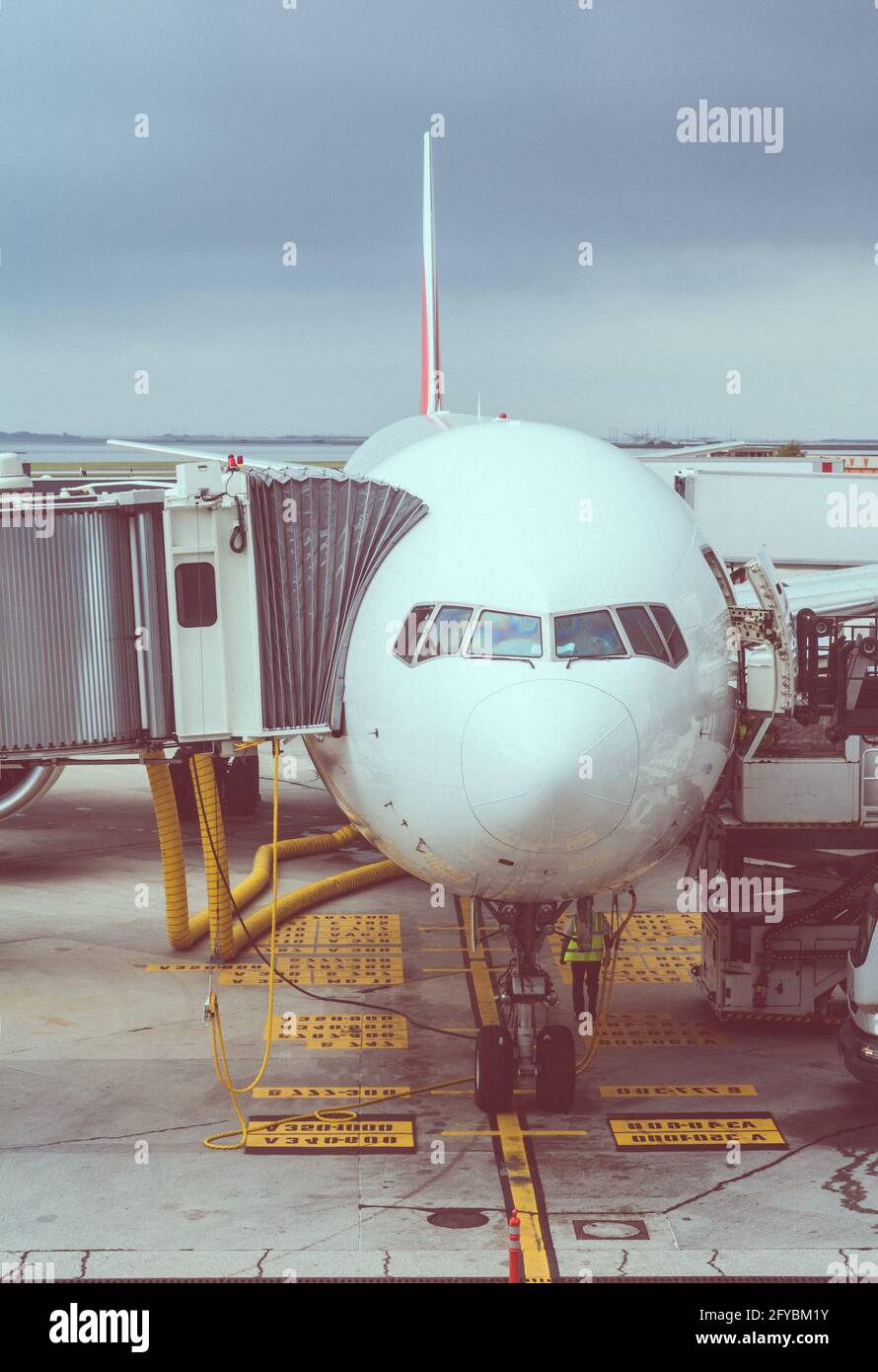 White Airplane docked to bridge terminal waiting for passangers Stock ...