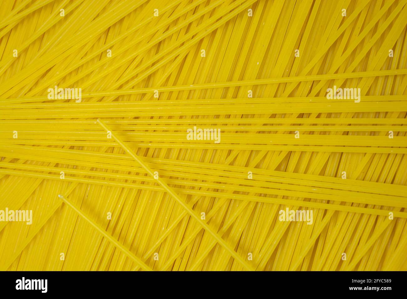 Abstract background of long and thin spaghetti. Raw pasta. Culinary ...