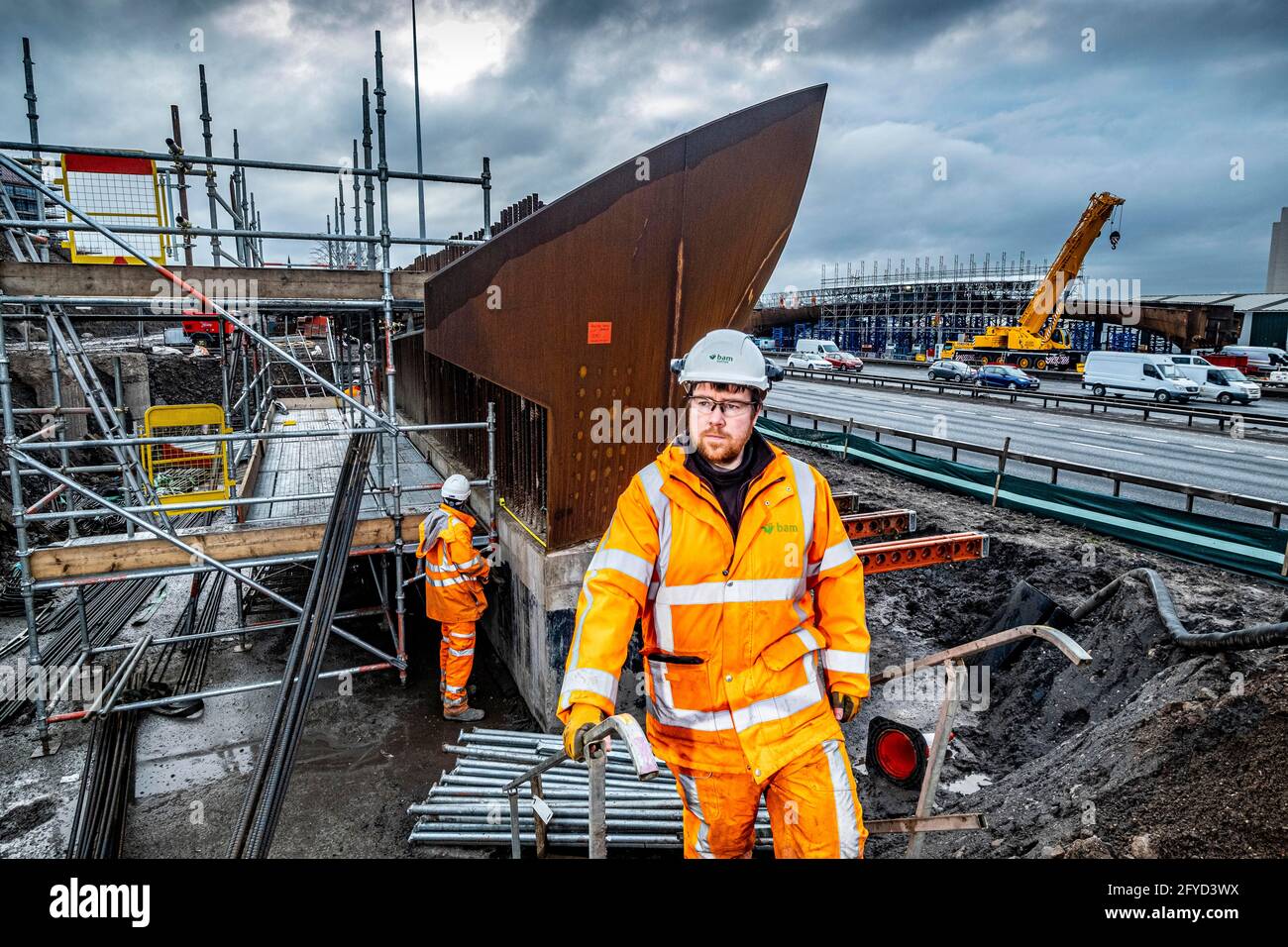 Construction workers in action on construction site Stock Photo - Alamy