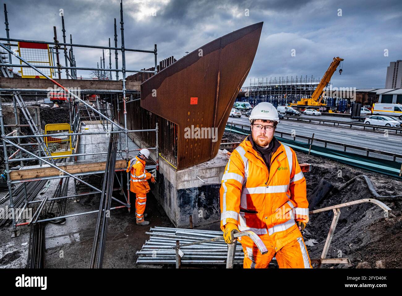 Construction workers in action on construction site Stock Photo - Alamy