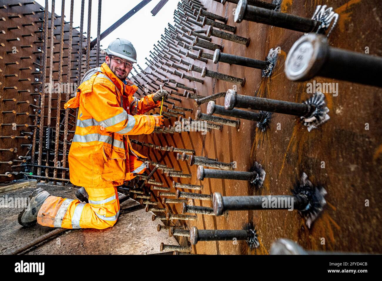 Construction workers in action on construction site Stock Photo - Alamy