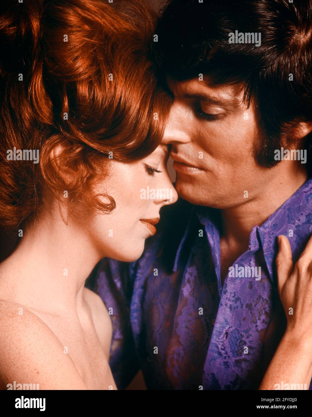 1970s ROMANTIC COUPLE YOUNG WOMAN BARE SHOULDERS WITH RED HAIR AND ...