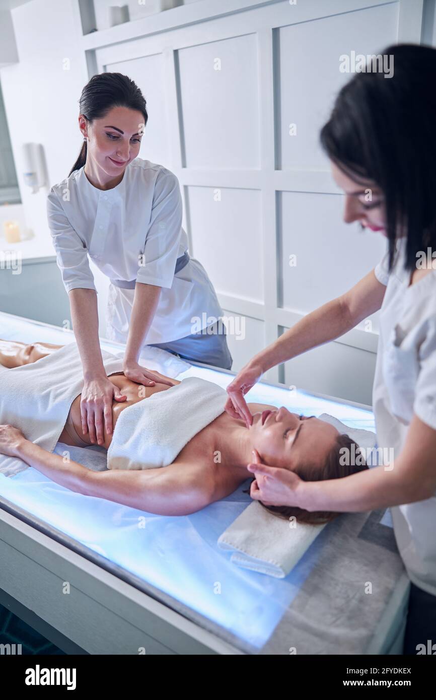 Pretty charming caucasian lady enjoying and relaxing at the spa complex ...