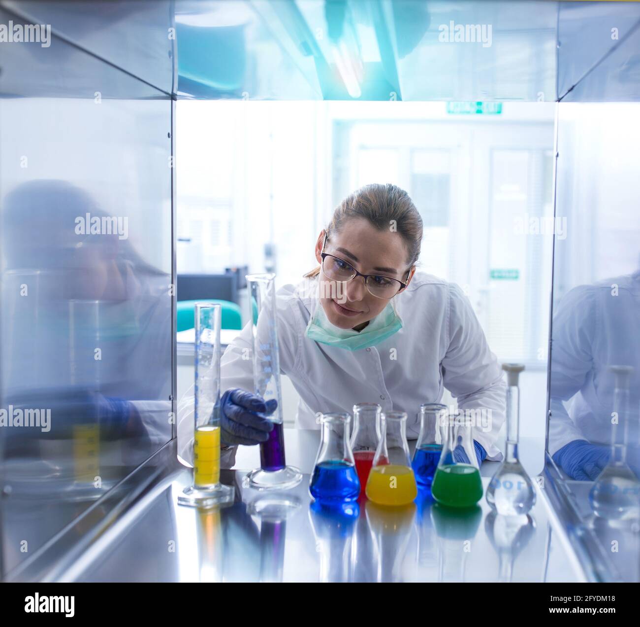 Woman working in laboratory doing research experiment. Young scientist ...