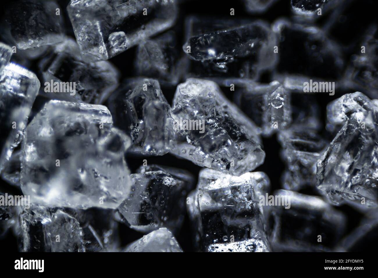 Crystal sugar close up on black background under the light microscope ...