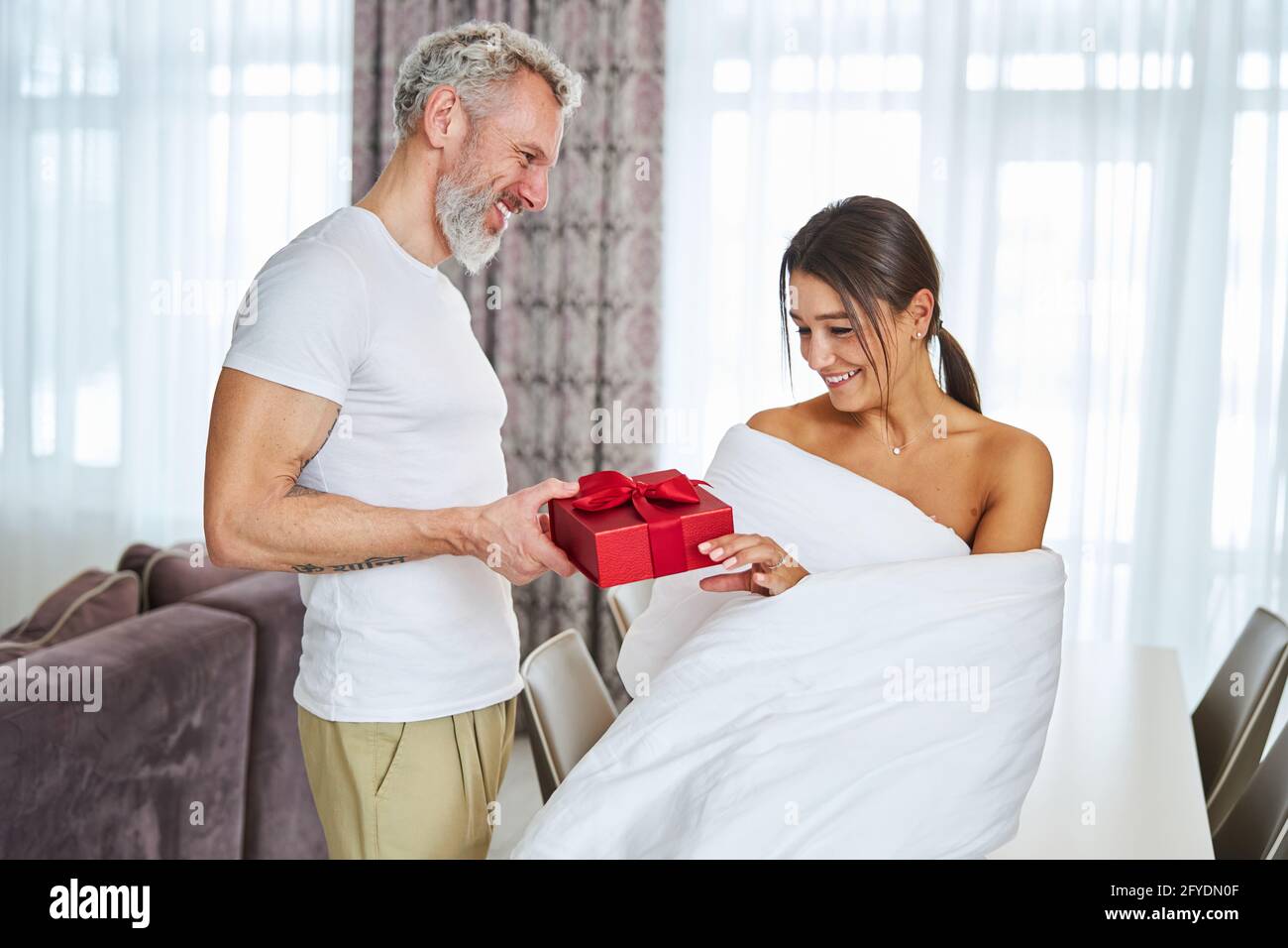 Handsome male giving gift hi-res stock photography and images - Alamy