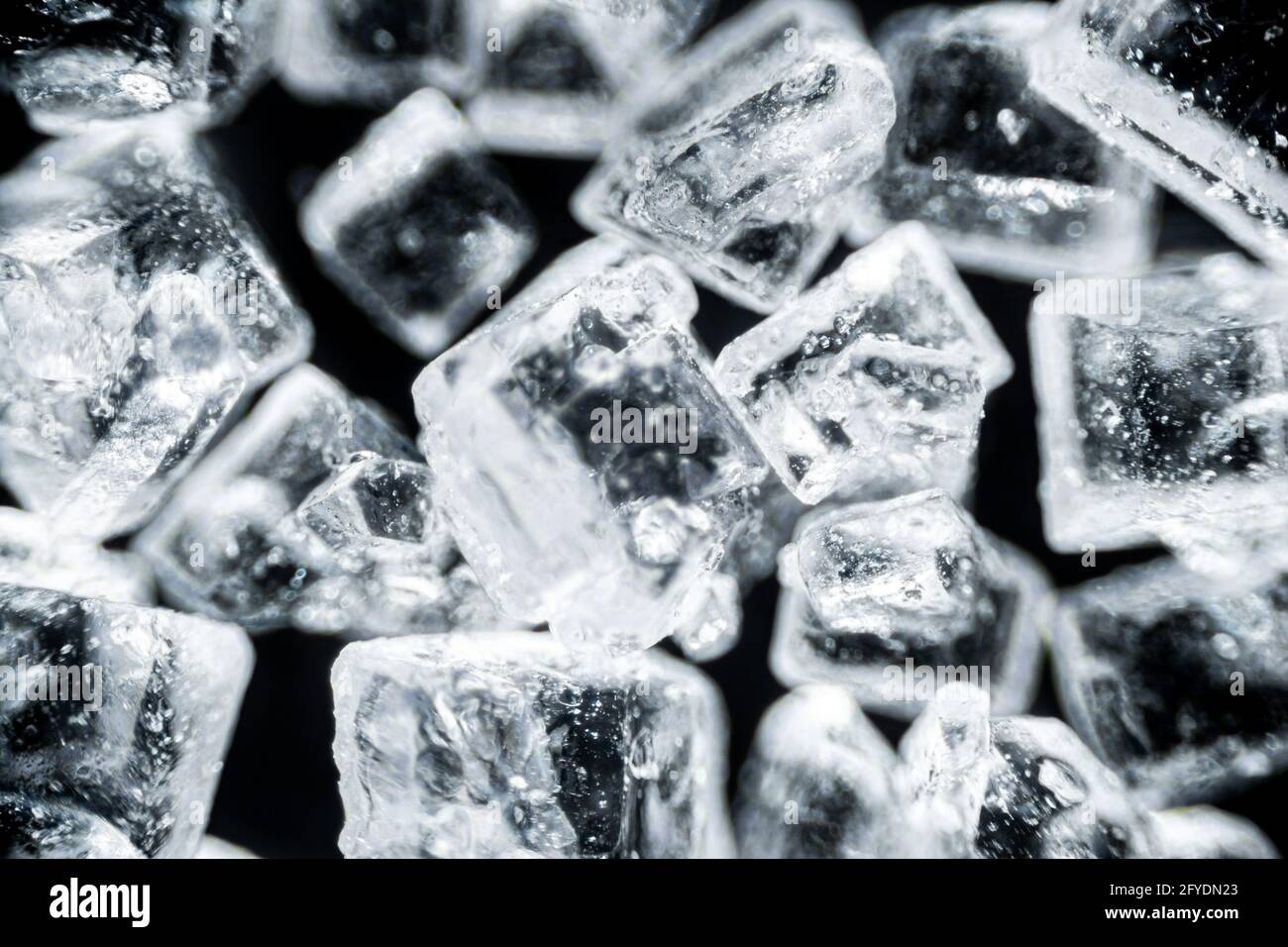 Crystal sugar close up on black background under the light microscope ...