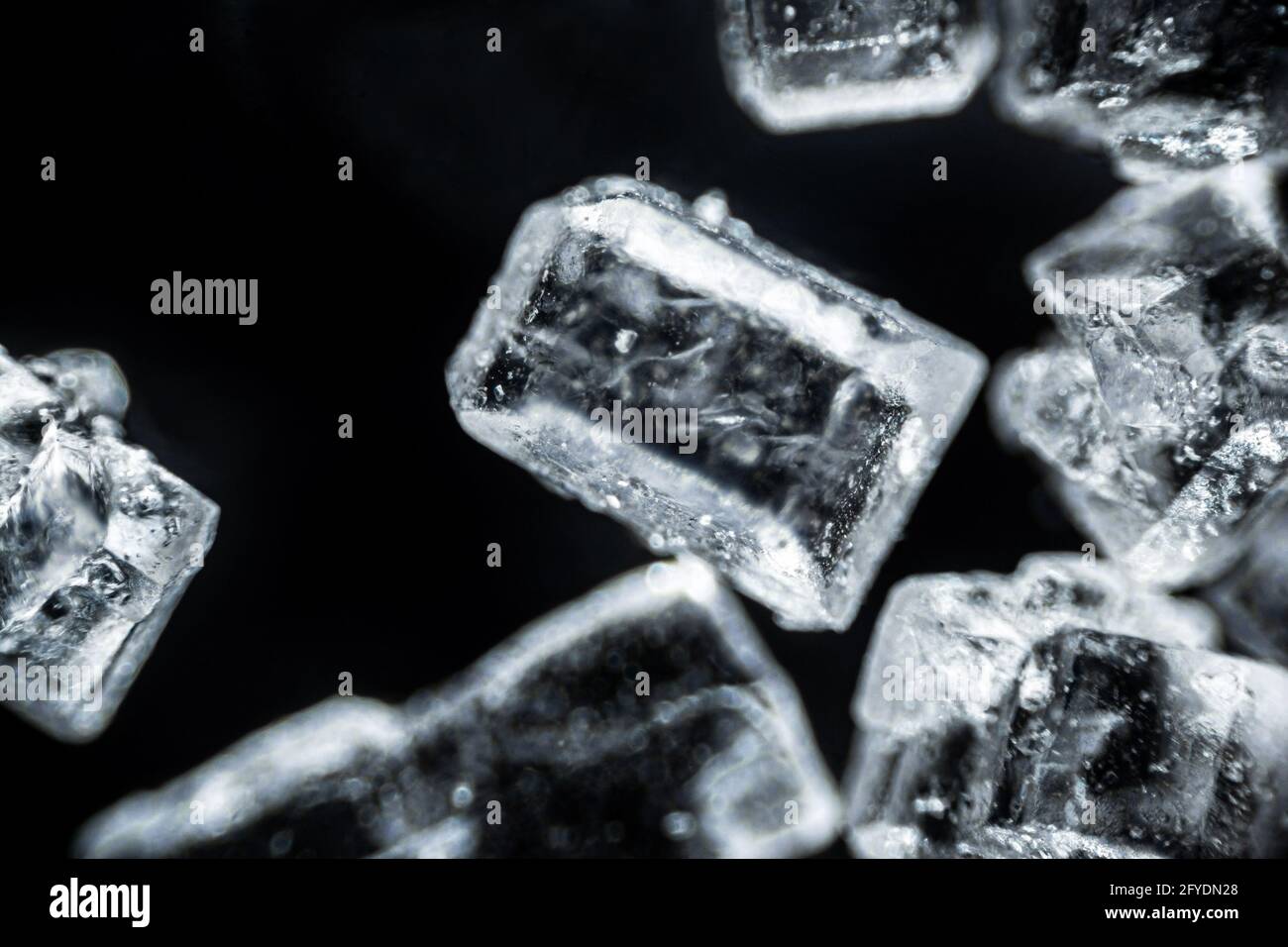 Crystal sugar macro on black background under the light microscope ...