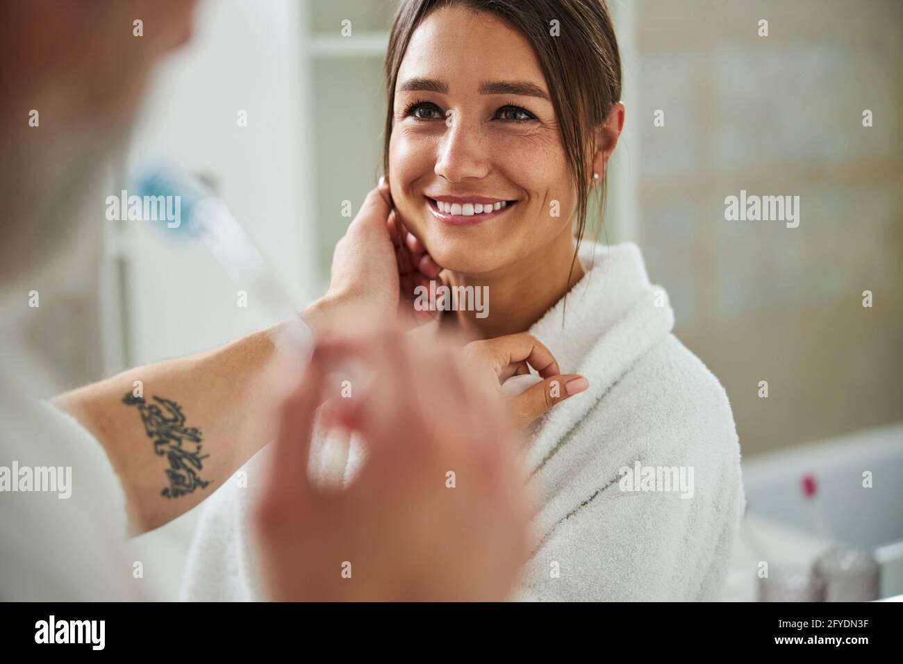 Happy charming lady in home clothes smiling in bathroom Stock Photo - Alamy