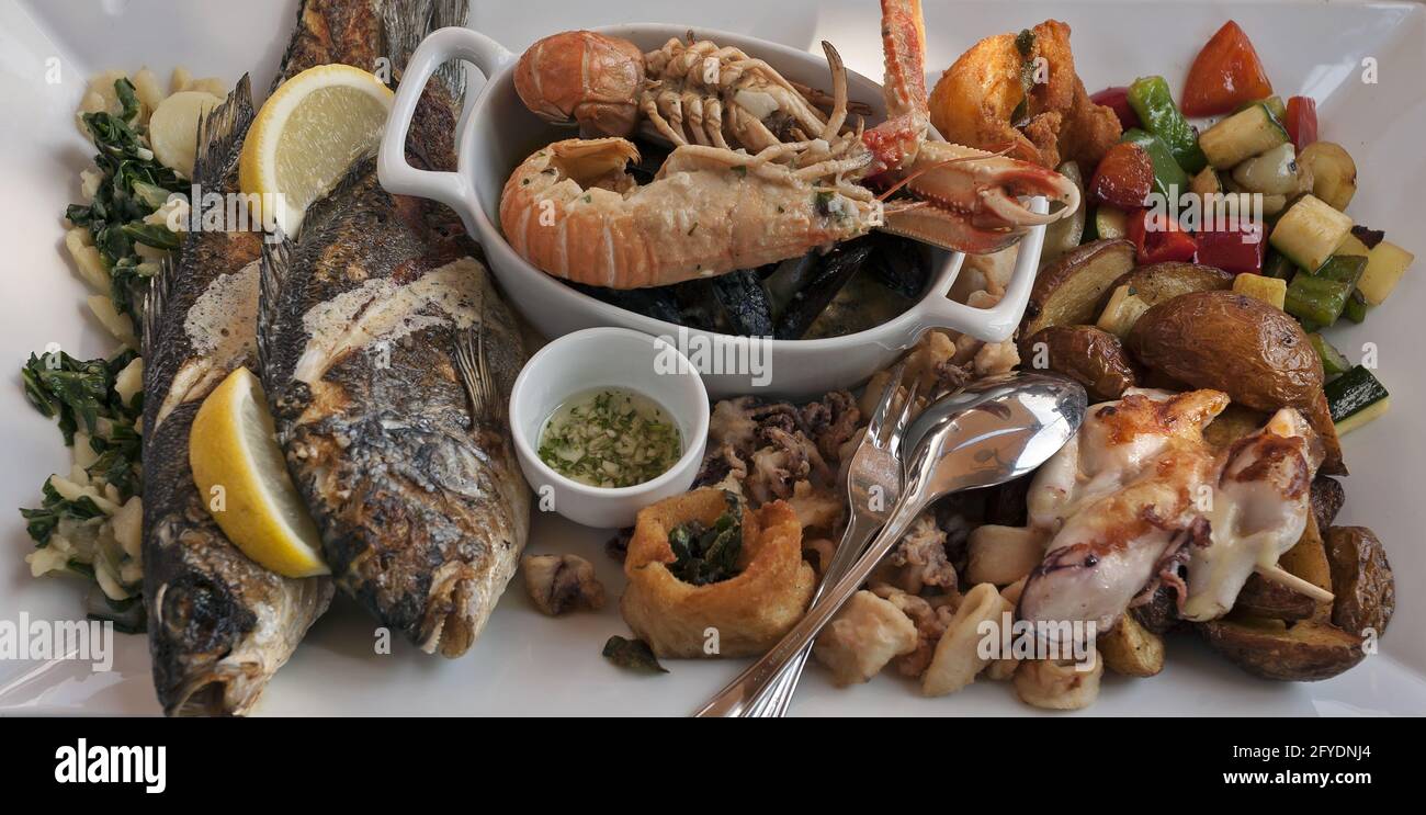 Mixed seafood with Vegetables feast on the white plate Stock Photo - Alamy