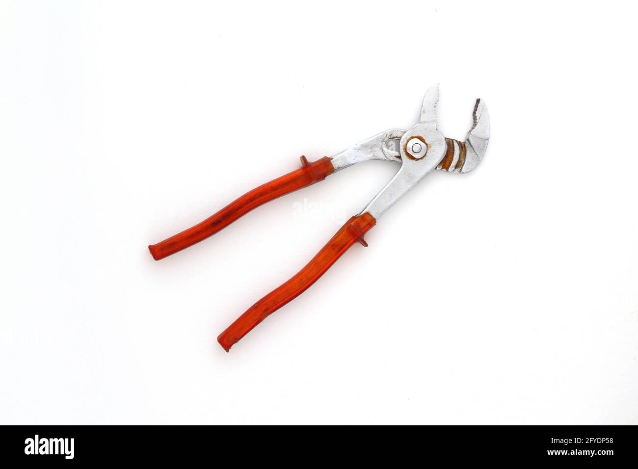Aerial view old and rusty pliers with red handle in horizontal position ...
