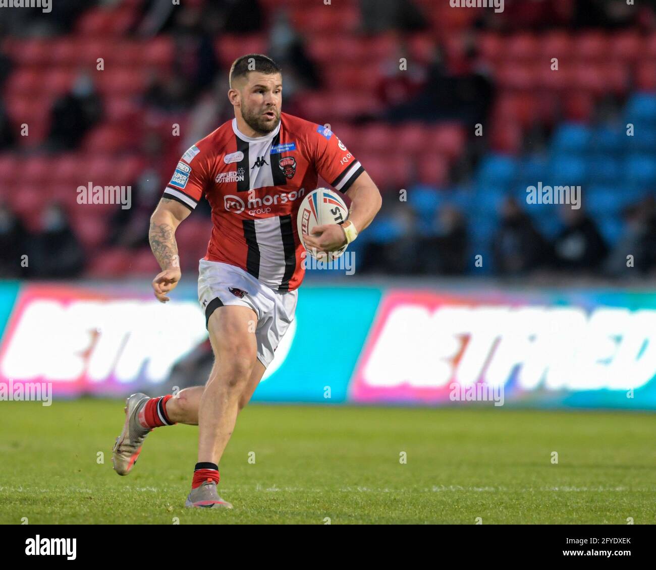 Ryan Lannon (11) of Salford Red Devils runs forward with the ball Stock ...