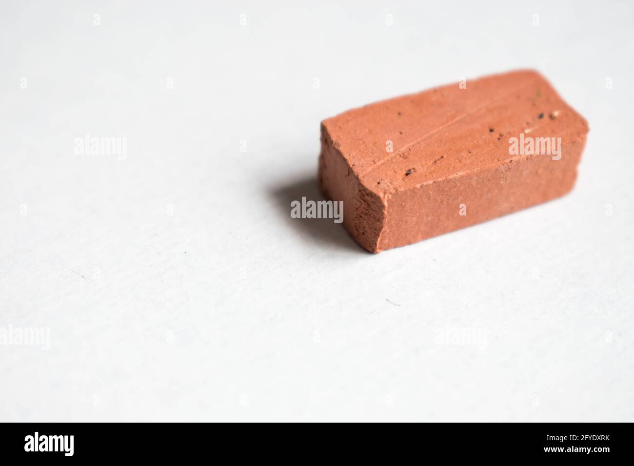One orange brick alone on a bright white background Stock Photo - Alamy