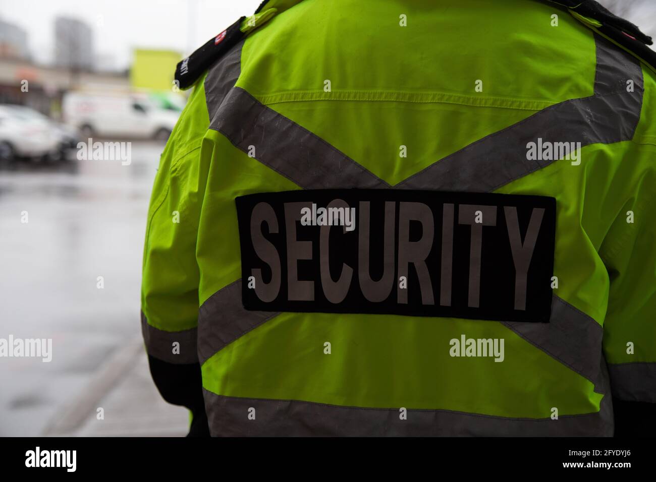 Security guard. Watching over parking area. Security guard is ...