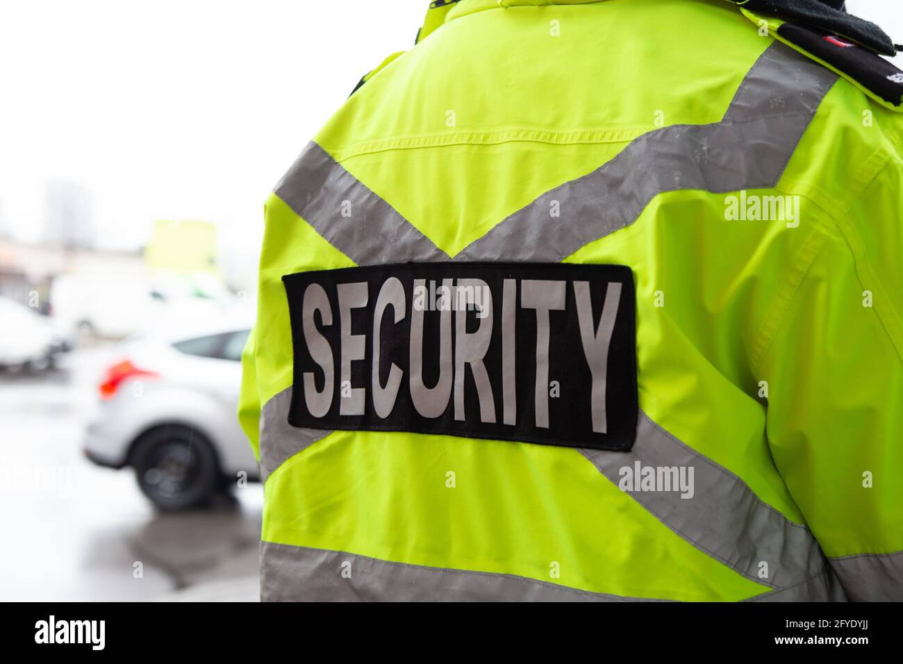Security guard. Watching over parking area. Security guard is ...