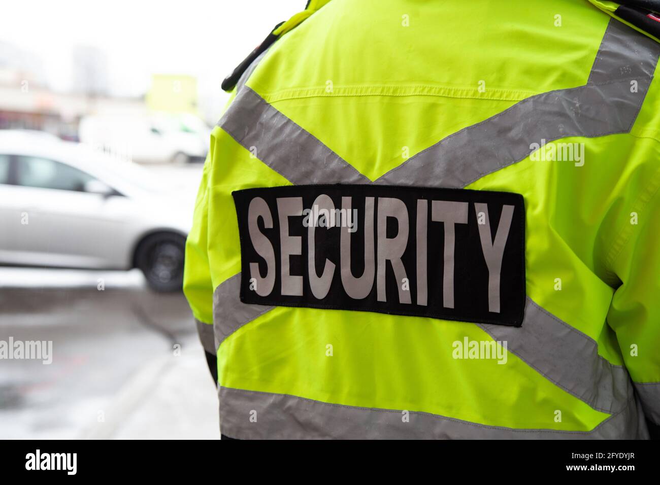 Security guard. Watching over parking area. Security guard is ...
