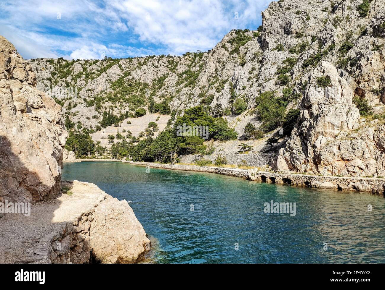 Beautiful transparent water in fjord like sea bay surrounded by cliffs ...