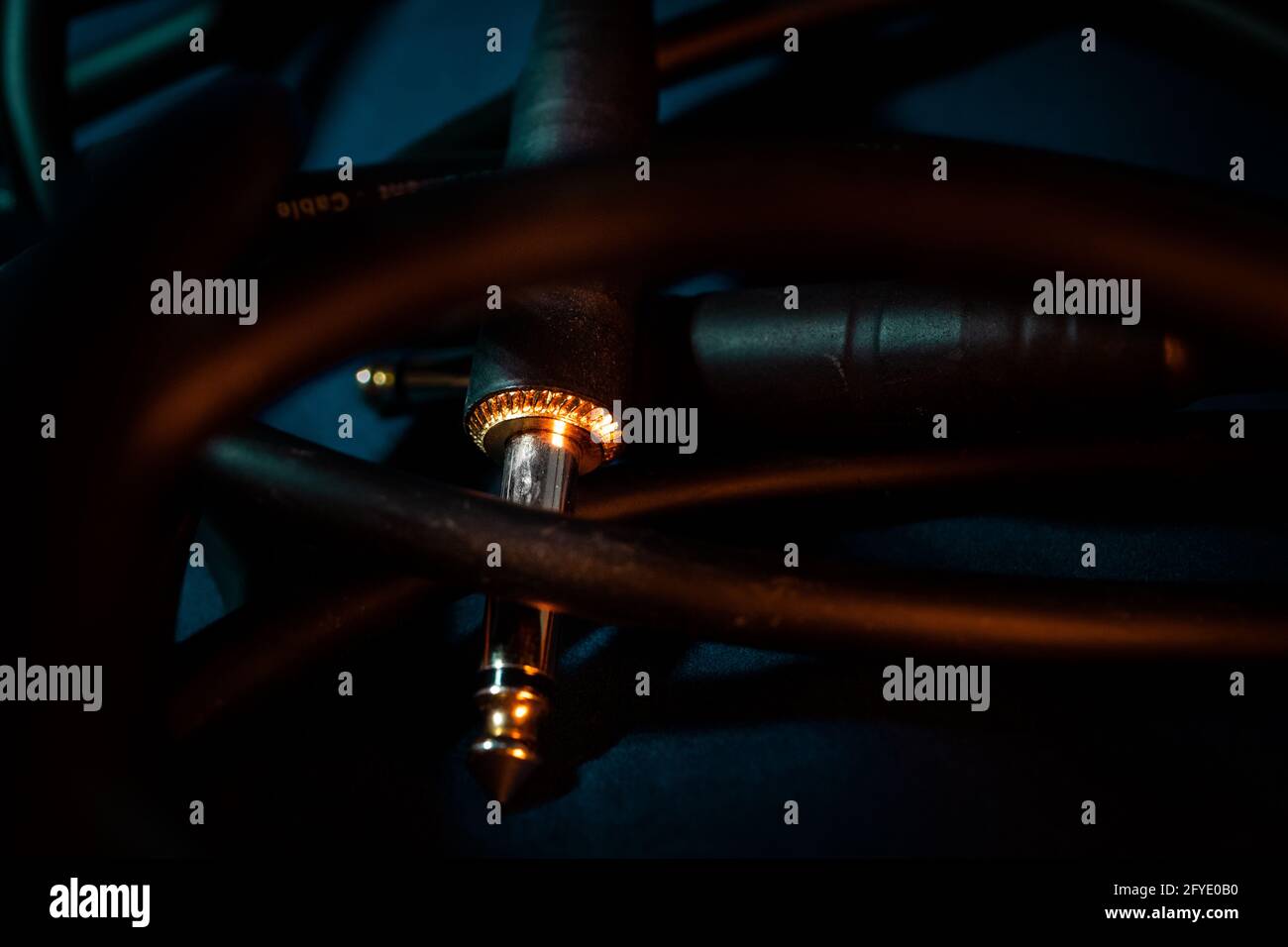 Closeup of Quarter Inch Jack Laying in Tangled Cord on Teal Background ...