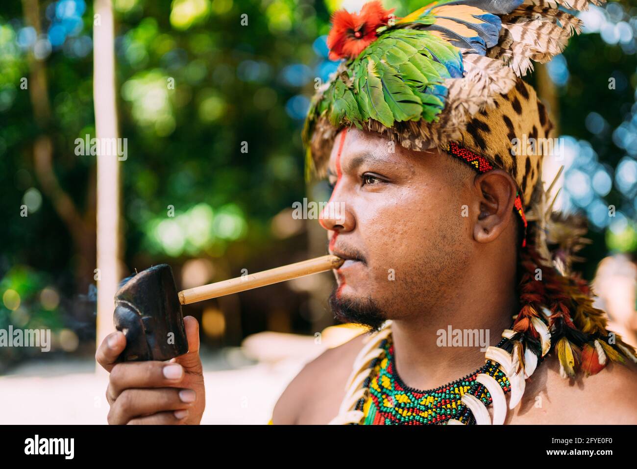 Indian chief from the Pataxó tribe smoking pipe . Brazilian Indian with ...